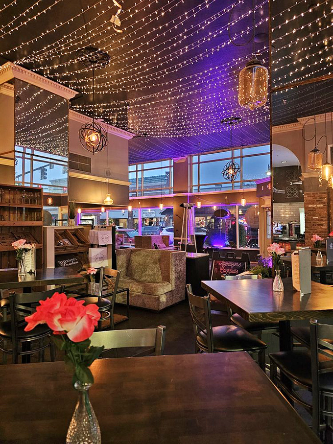 Twinkling lights create a canopy of stars indoors, transforming this underground haven into a magical dining galaxy where comfort meets elegance.