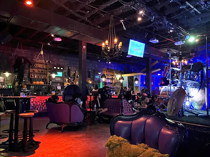Plush velvet seating and atmospheric lighting create the perfect setting for sipping spooky concoctions while surrounded by horror-inspired d&eacute;cor.