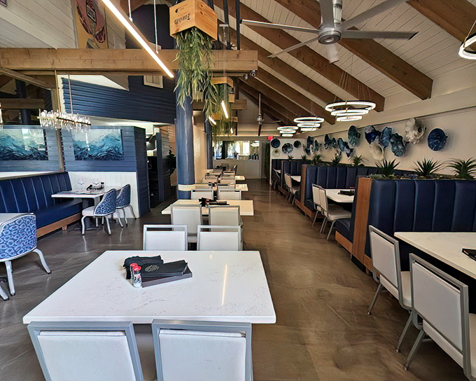 The interior blends coastal elegance with natural elements &ndash; soaring ceilings, wooden beams, and blue accents create an atmosphere that's both sophisticated and welcoming.