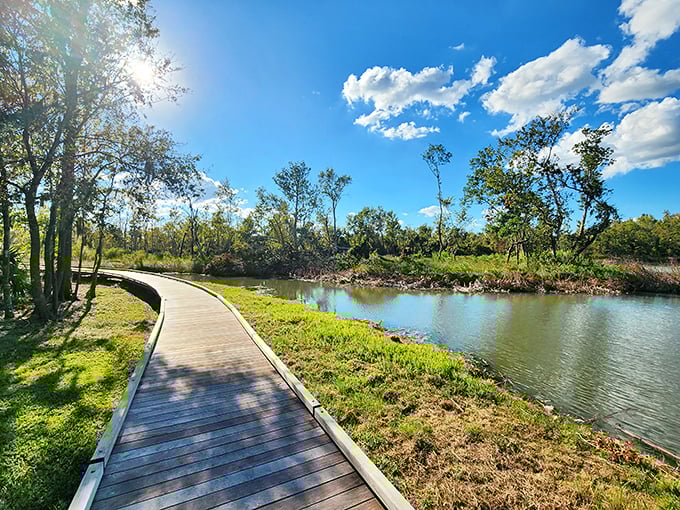 A serene boardwalk hugs the shoreline, where the morning light plays across the water and whispers, "Put down your phone and stay awhile."