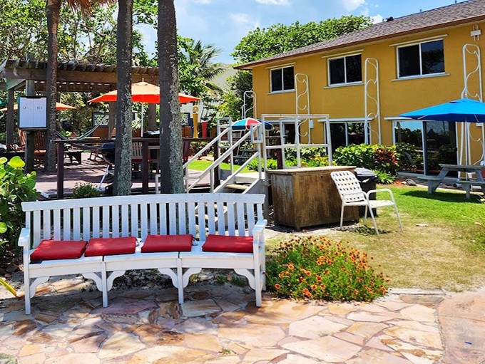 A cheerful yellow cottage surrounded by tropical gardens &ndash; like your favorite aunt's beach house, but with better landscaping.