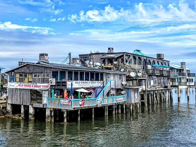 Cedar Key's weathered wooden buildings stand on stilts over the water, creating a timeless coastal scene straight from Florida's fishing village past.