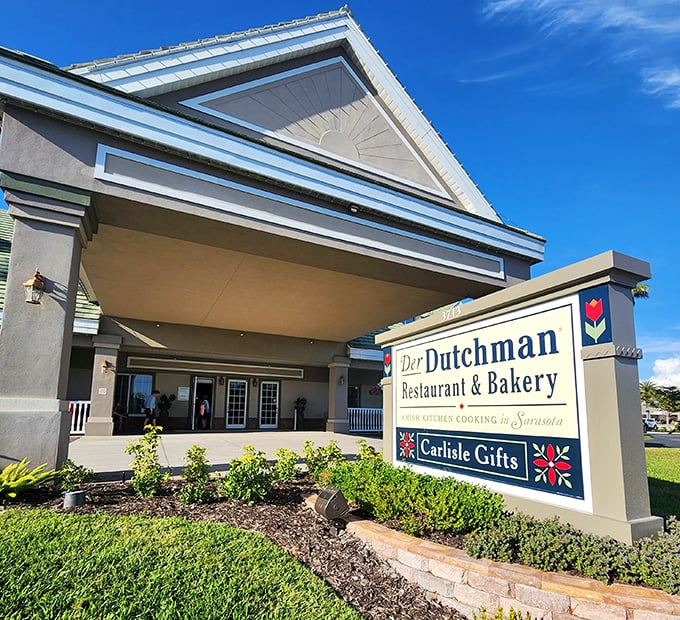 Der Dutchman's impressive exterior stands proudly in Sarasota, promising Amish culinary delights within its welcoming walls. The perfect stop for hungry travelers!