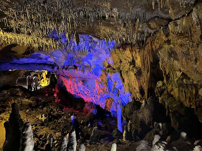 Underground chambers glow with otherworldly colors, like nature's own art gallery carved from solid rock.
