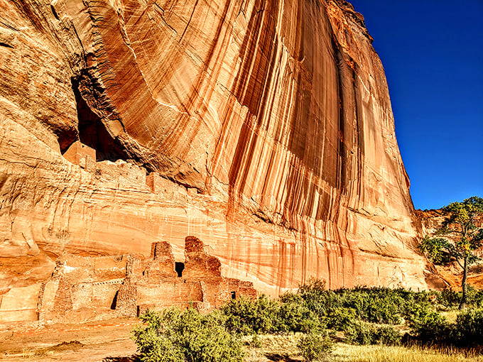 Ancient cliff dwellings nestle beneath striped sandstone walls. Canyon de Chelly's White House Ruins tell silent stories of the people who called this magnificent place home.