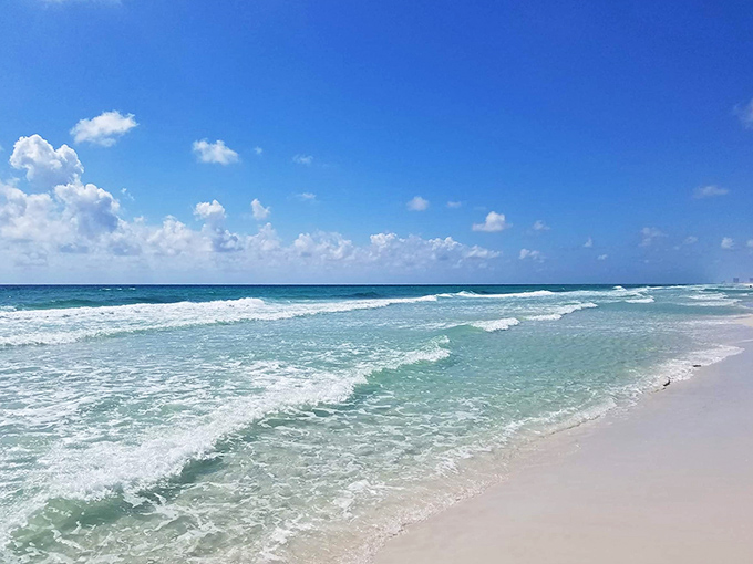 Gentle waves kiss sugar-white shores at Gulf Islands National Seashore, creating a beach experience that rivals any Caribbean destination.