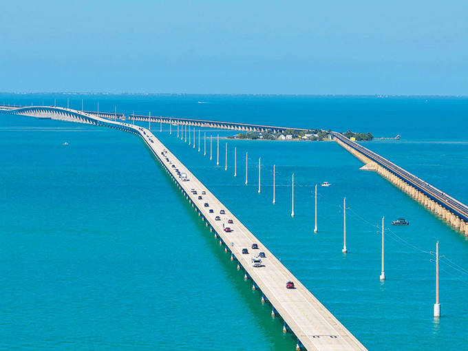 The Seven Mile Bridge offers drivers a surreal experience of seemingly floating above turquoise waters, connecting the middle and lower Florida Keys.