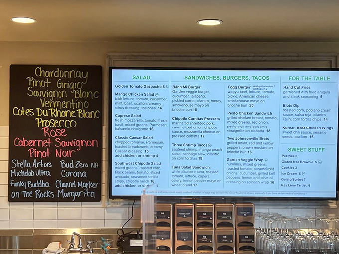 The chalkboard wine list promises liquid sunshine in a glass, while the digital menu teases taste buds with garden-inspired delights.