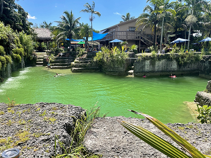 Terraced stone steps lead down to refreshing waters, where families create memories against a backdrop of tropical splendor.