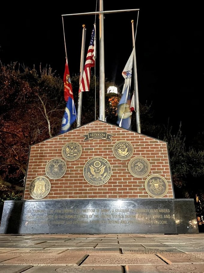 The Veterans Memorial stands as a solemn tribute near the lighthouse, honoring those who served with the same steadfast dedication as the beacon itself.