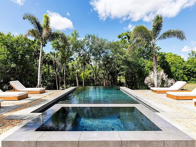 Nature becomes the backdrop for this serene infinity pool, where the water's edge seems to merge with the lush landscape beyond.