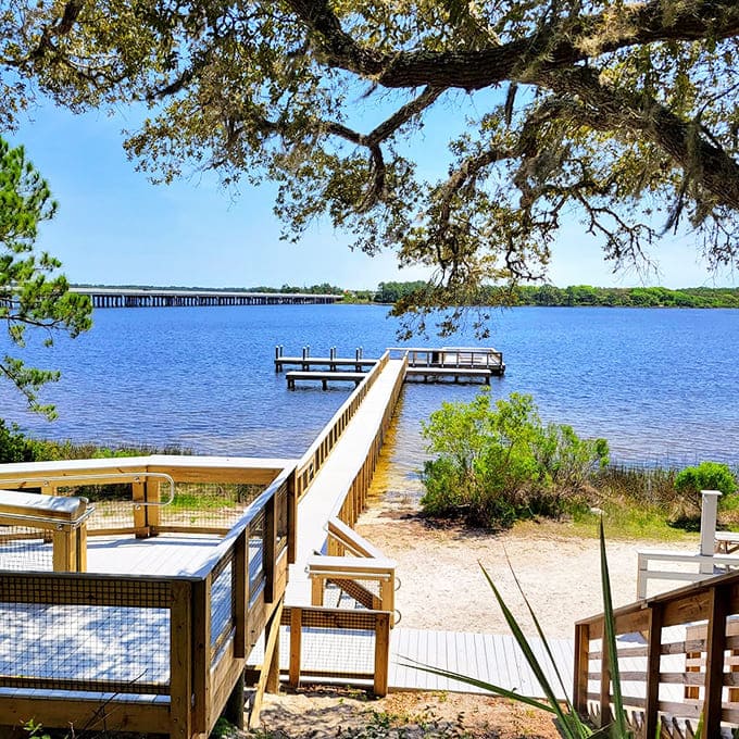 A peaceful dock extends into calm waters where fishing and quiet reflection go hand in hand perfectly.