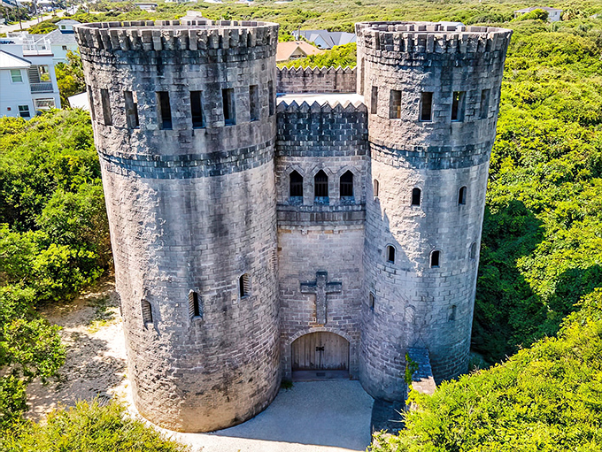 Castle Otttis rises from the Florida landscape like a medieval mirage, its twin stone towers and fortress-like design creating an unexpected Irish vision against the coastal backdrop.