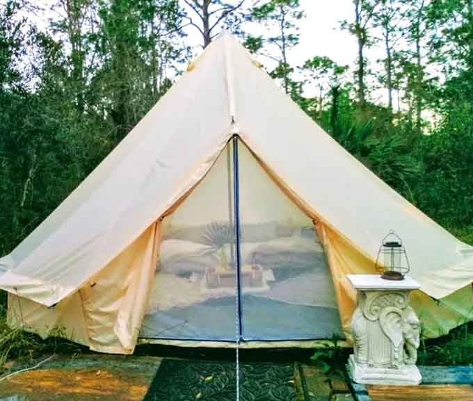 This canvas tent looks fancier than some hotel rooms, with a bed that promises sweet dreams under the stars.