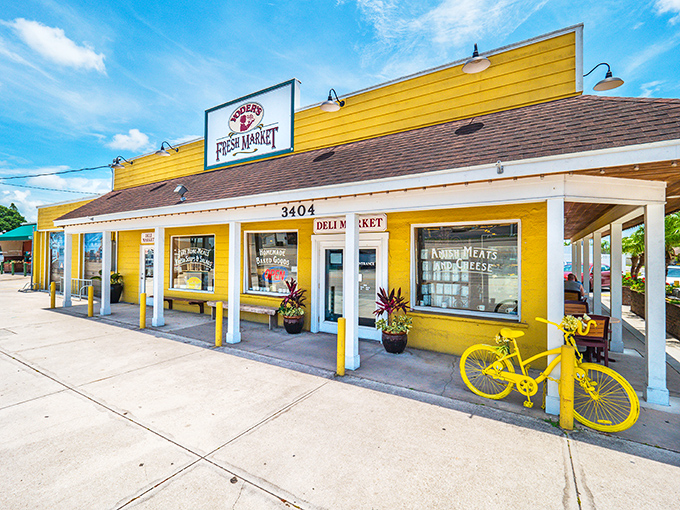 Yoder's Fresh Market's cheerful yellow building brightens Bahia Vista Street. The whimsical yellow bicycle adds a touch of charm to this delightful food destination.