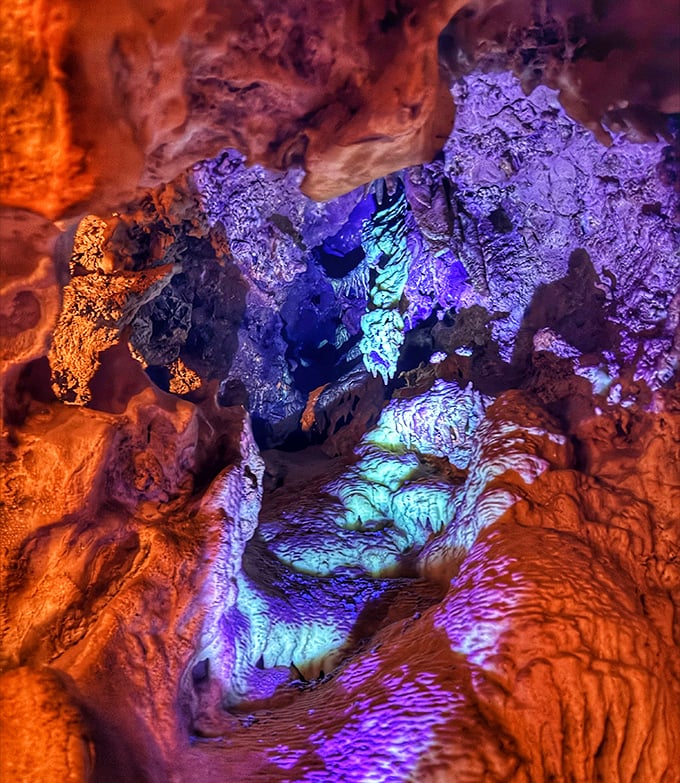 Colorful lights illuminate the cave's otherworldly interior. Stalactites and stalagmites create a magical underground landscape that stays 70 degrees year-round.