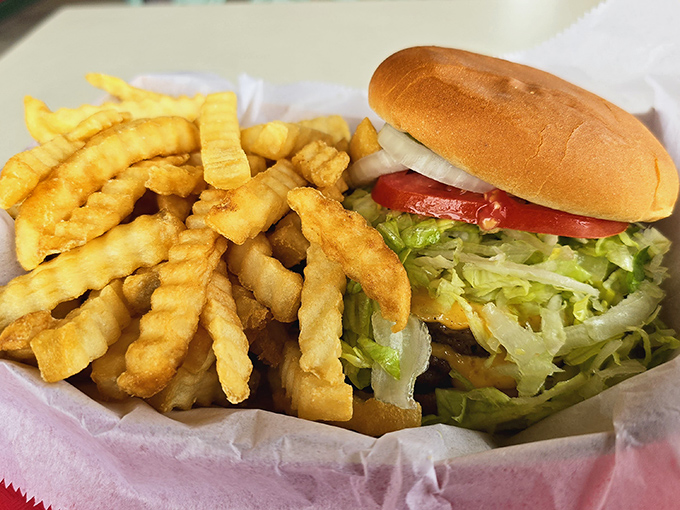 This isn't just a burger; it's an architectural achievement of beef, bun, and crispy fries that makes salad seem like a terrible life choice.