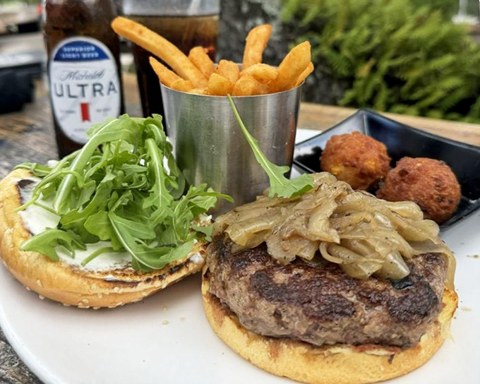 This isn't just any burger &ndash; it's the Woods Burger, featuring house-ground PRIME brisket topped with goat cheese and caramelized onions that might make you forget you're at a seafood restaurant.