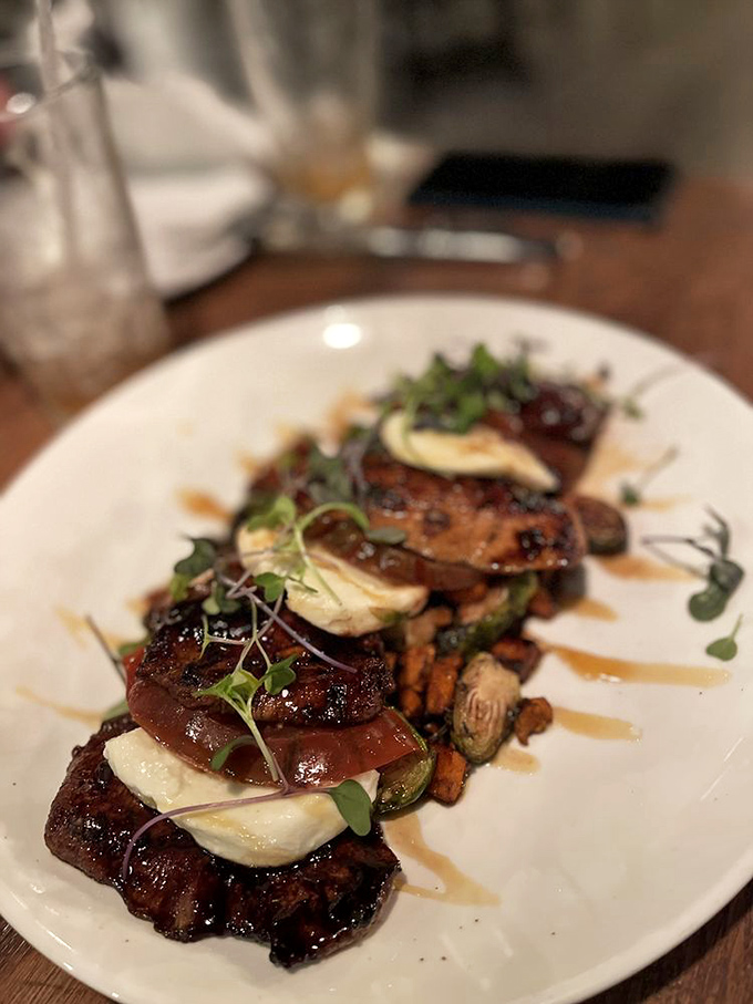 Perfectly seared medallions layered with creamy cheese and caramelized vegetables &ndash; proof that underground dining reaches new culinary heights.