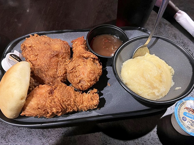 Golden-fried chicken that shatters with each bite, served alongside creamy mashed potatoes and gravy – comfort food that revs up the taste buds.