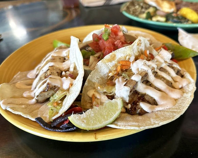 Fish tacos dressed up with all the fixings, proving that handheld meals can be sophisticated and messy simultaneously.