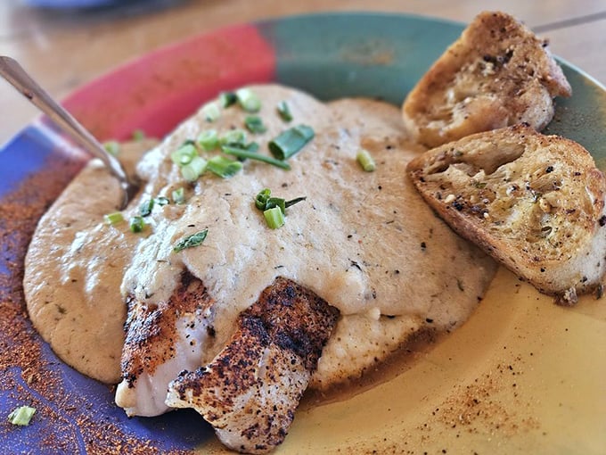 Blackened grouper lounging on a bed of creamy cheese grits &ndash; a Southern romance that makes taste buds swoon.