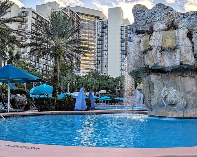 The lagoon pool winds through the property like a tropical river, with the hotel rising impressively in the background.