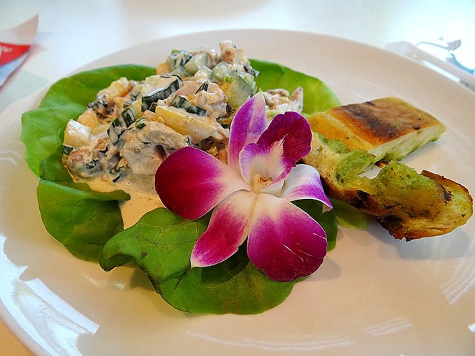 Not your average chicken salad! This artful creation comes garnished with an orchid so pretty you almost feel guilty eating it. Almost.