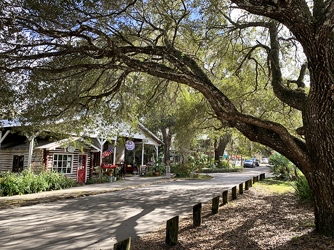 The Trading Outpost stands like a cheerful yellow sentinel, its porch practically begging you to browse treasures you never knew you needed.