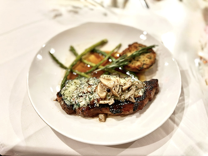 A perfectly seared steak that doesn't need a passport to feel worldly. That herb-flecked butter melting on top is performing culinary magic before your eyes.