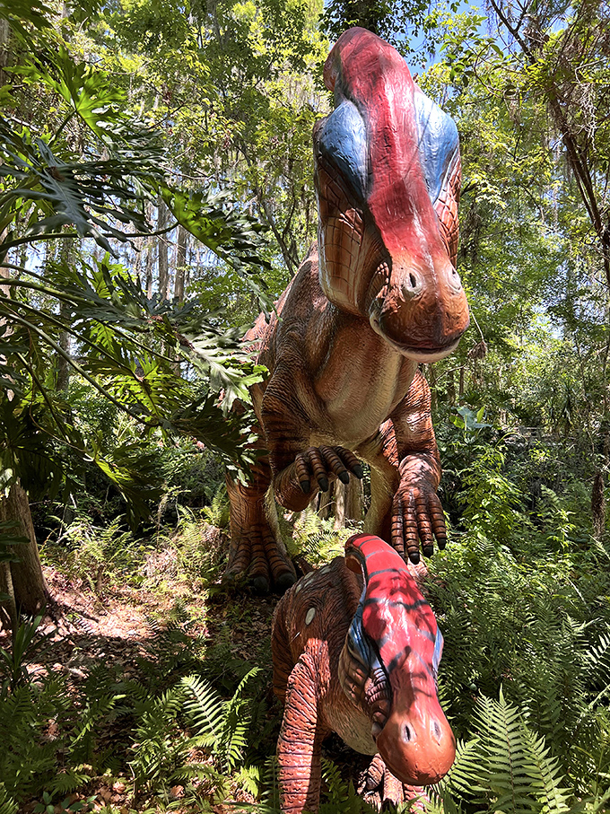 Parasaurolophus parents watch over their young amid lush Florida foliage, creating a touching prehistoric family portrait.
