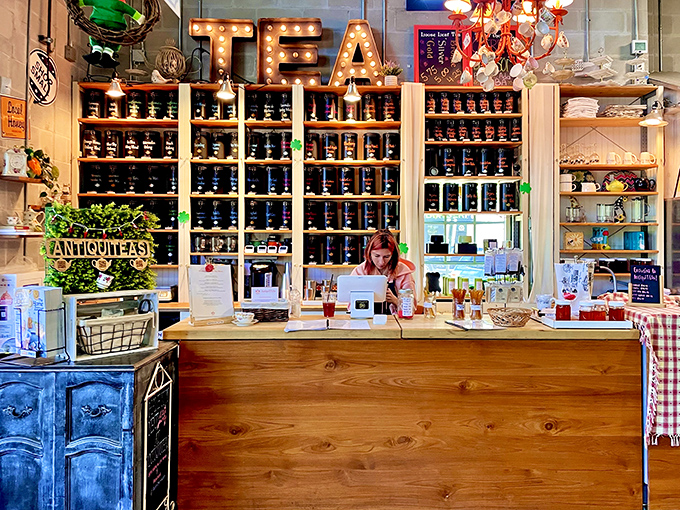The tea shop's illuminated "TEA" sign beckons caffeine seekers to explore shelves stocked with leaves from around the world.