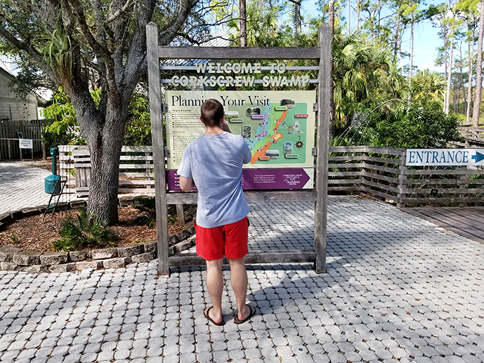 A visitor contemplates the trail map, plotting his journey through this labyrinth of natural wonders – decisions, decisions!