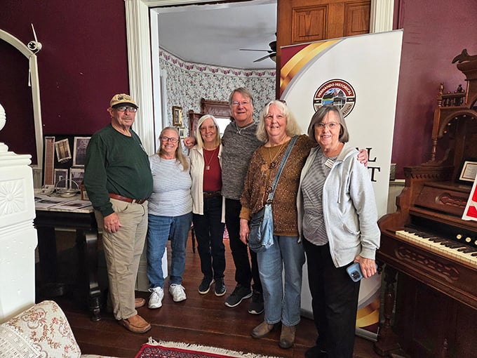Visitors gather in the parlor, unaware they might not be alone. The house welcomes history enthusiasts and ghost hunters alike.