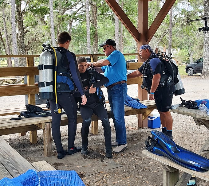 Diving preparations underway as enthusiasts gear up for underwater exploration, trading nervous excitement and equipment tips.