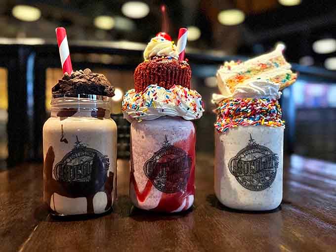 These aren't just milkshakes&mdash;they're architectural marvels topped with entire desserts! Each one arrives like a sweet skyscraper that demands to be photographed before consumed.