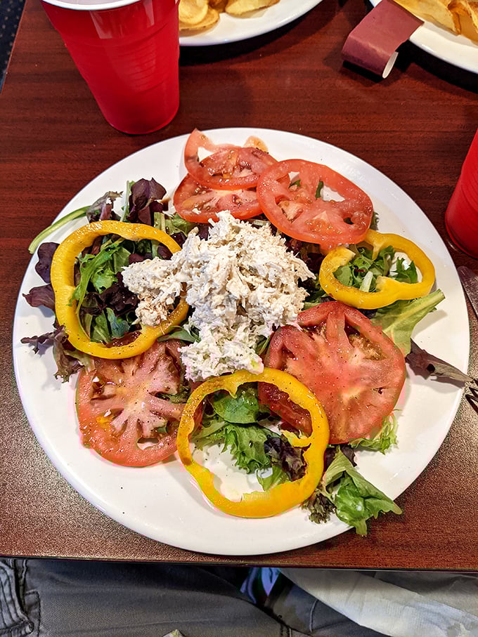 Fresh greens cradle homemade chicken salad while yellow peppers add sunny rings of sweetness to this refreshing plate.
