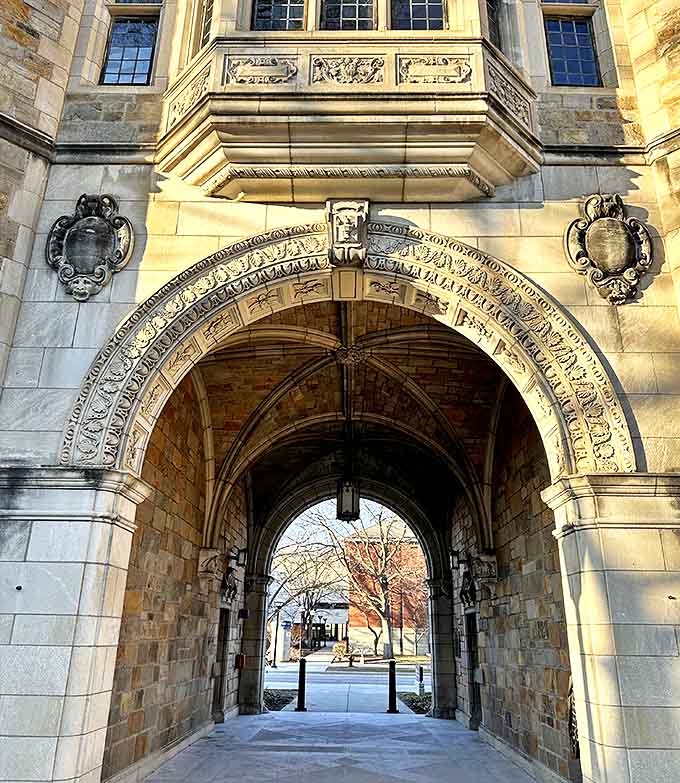 Intricate stonework surrounds this grand entrance, where elaborate carvings tell silent stories to everyone who passes beneath the weathered arch.