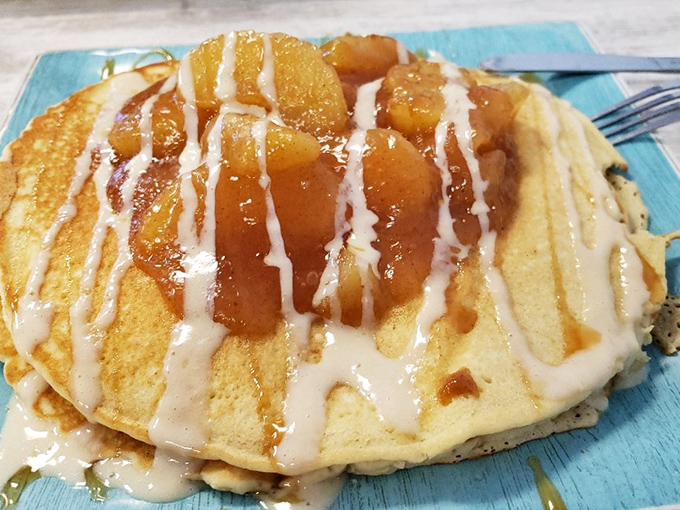 These golden pancakes topped with caramelized apples and cream drizzle aren't just breakfast – they're an edible sunrise that makes morning people out of night owls.