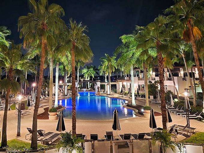 Palm trees frame this illuminated pool like nature's own nightclub. The perfect spot for an evening dip while contemplating tomorrow's tee time.