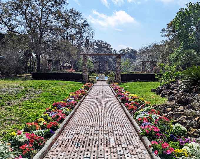 Brick pathways lead through gardens where flowers bloom in every direction and peace fills the air.