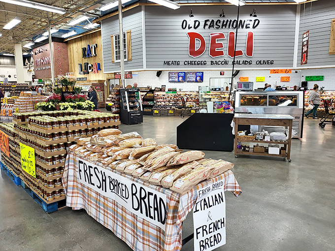Fresh-baked bread takes center stage at Detwiler's, with loaves of French and Italian varieties tempting shoppers. The deli counter in the background promises even more delights.