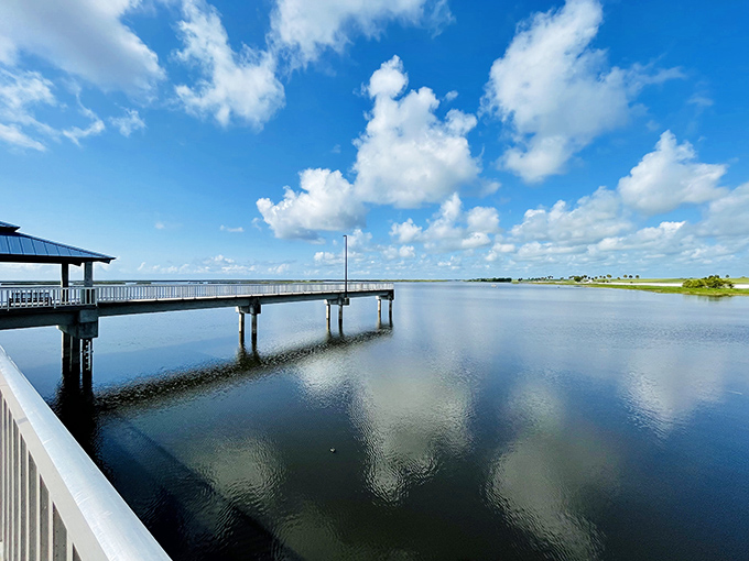 A viewing platform extends over Lake Okeechobee's waters, offering the perfect spot to watch for ospreys diving or alligators sunning along the shoreline.