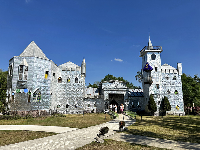 This handcrafted castle stands like a silver beacon among the green landscape, inviting visitors to explore its artistic treasures.