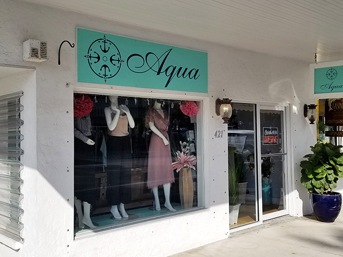 Aqua boutique showcases coastal-chic fashion behind flamingo-adorned windows, tempting shoppers with island-inspired treasures and resort wear.