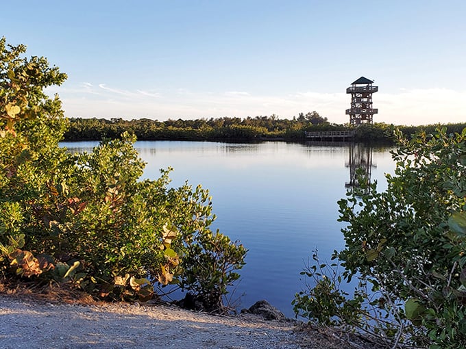 The tower reflects perfectly in still waters, creating a mirror image of this architectural highlight.