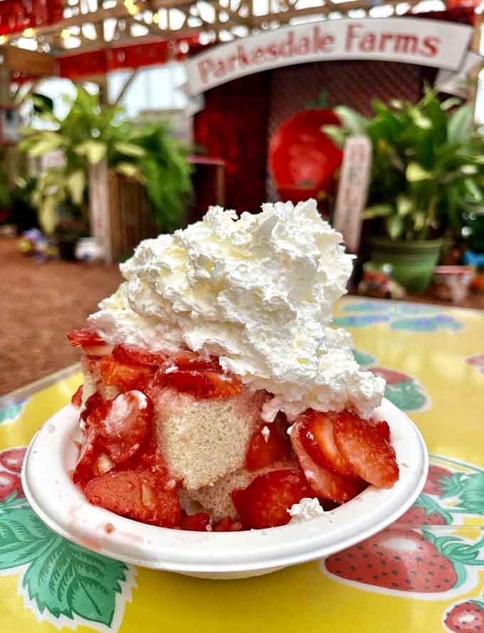 This towering creation proves that sometimes more is more, especially when strawberries and whipped cream are involved.
