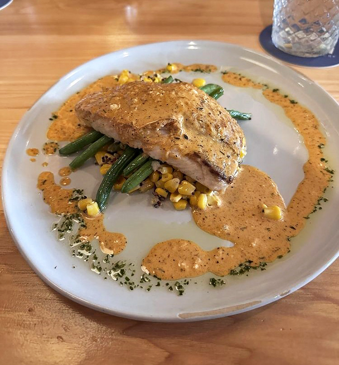 Red Snapper that was likely swimming this morning, now perfectly seared and served with seasonal vegetables. The sauce isn't covering up &ndash; it's celebrating.