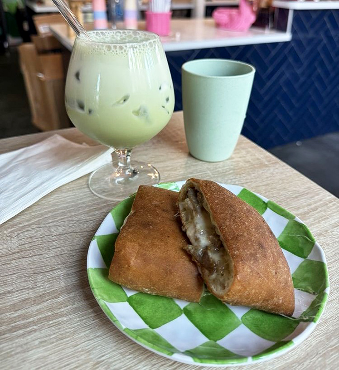 A matcha latte so vibrant it practically photosynthesizes, paired with a steak calzone that makes lunch feel like a special occasion.