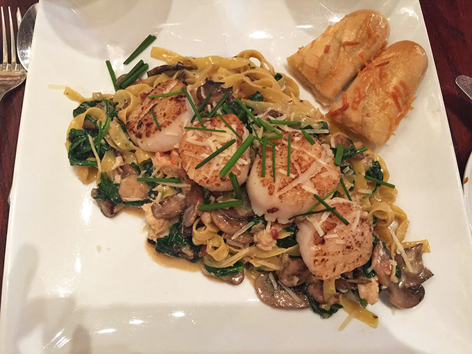 Perfectly seared scallops dance atop a bed of pasta, mushrooms, and greens &ndash; proof that sometimes the ocean's simplest gifts make the most spectacular dishes.